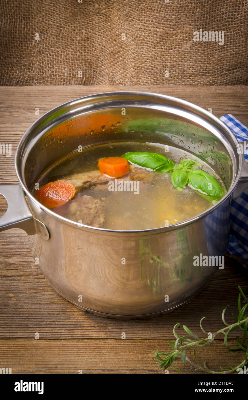Pot with broth Stock Photo - Alamy