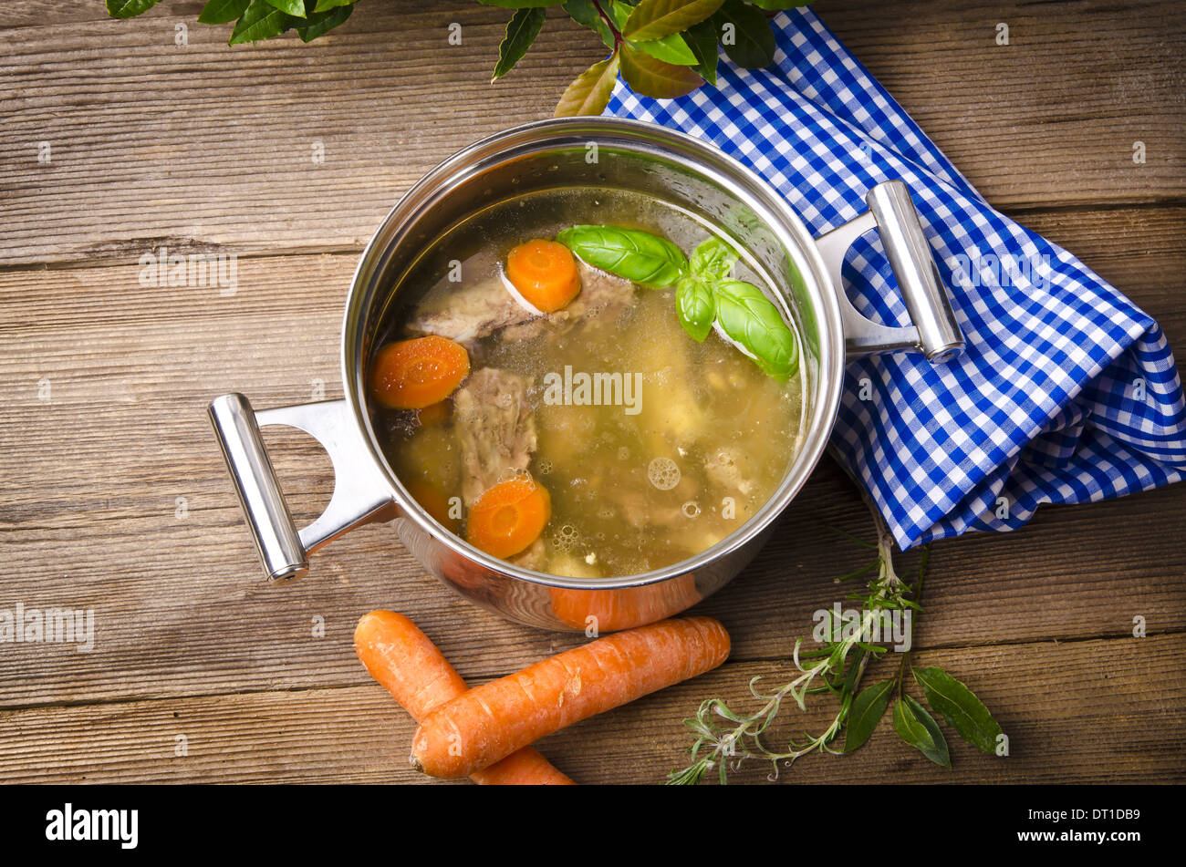 Pot with broth Stock Photo - Alamy
