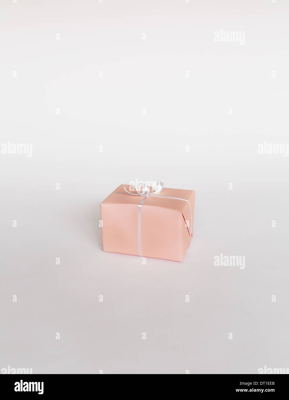 gift wrapped in pink paper with ribbon Stock Photo - Alamy