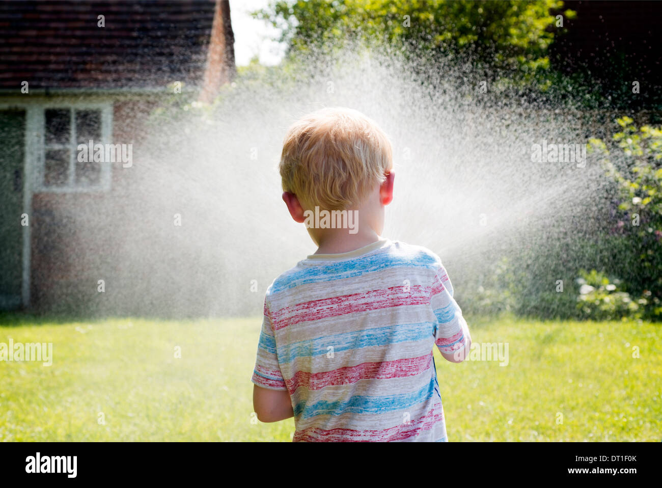 Water spraying boy hi-res stock photography and images - Alamy