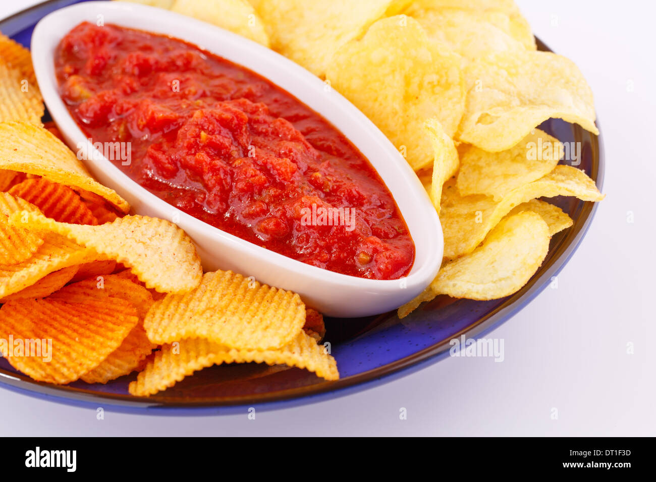 Potato chips and red sauce isolated on gray background Stock Photo - Alamy