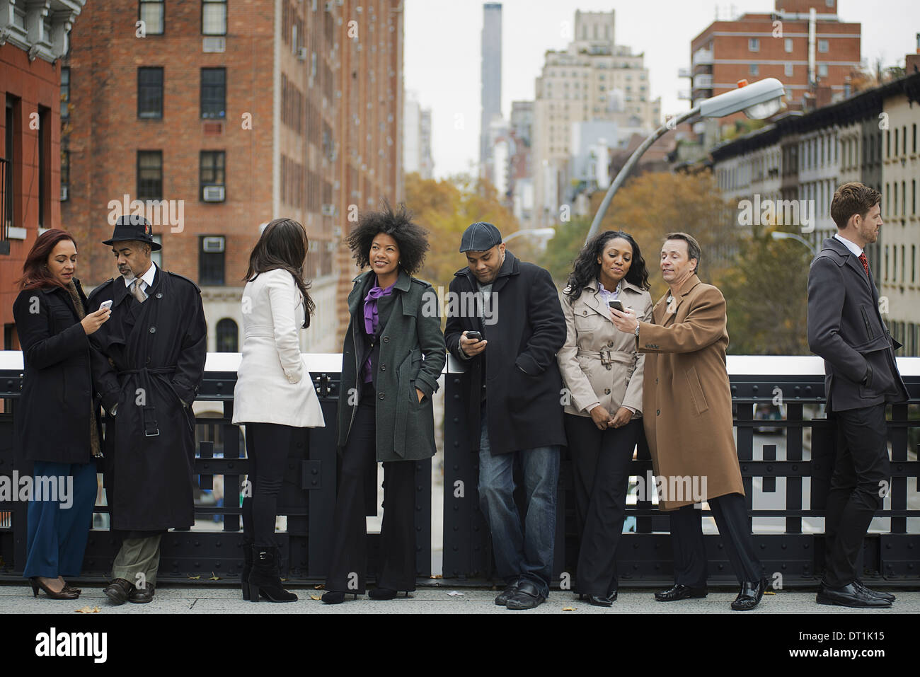 using mobile phones and talking to each other Standing in a line Stock ...