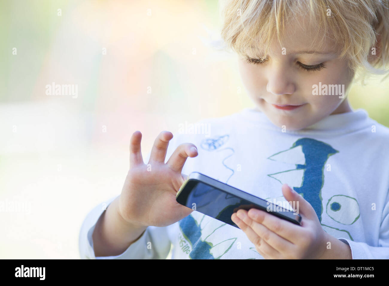 Little boy using smartphone Stock Photo - Alamy