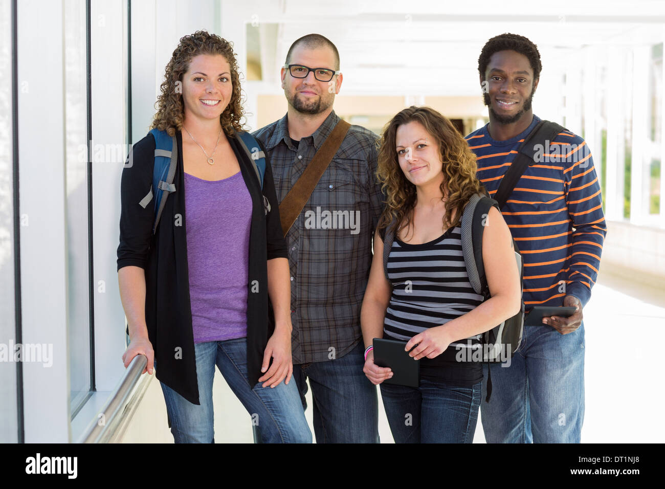 Confident University Students Standing At Corridor Stock Photo - Alamy
