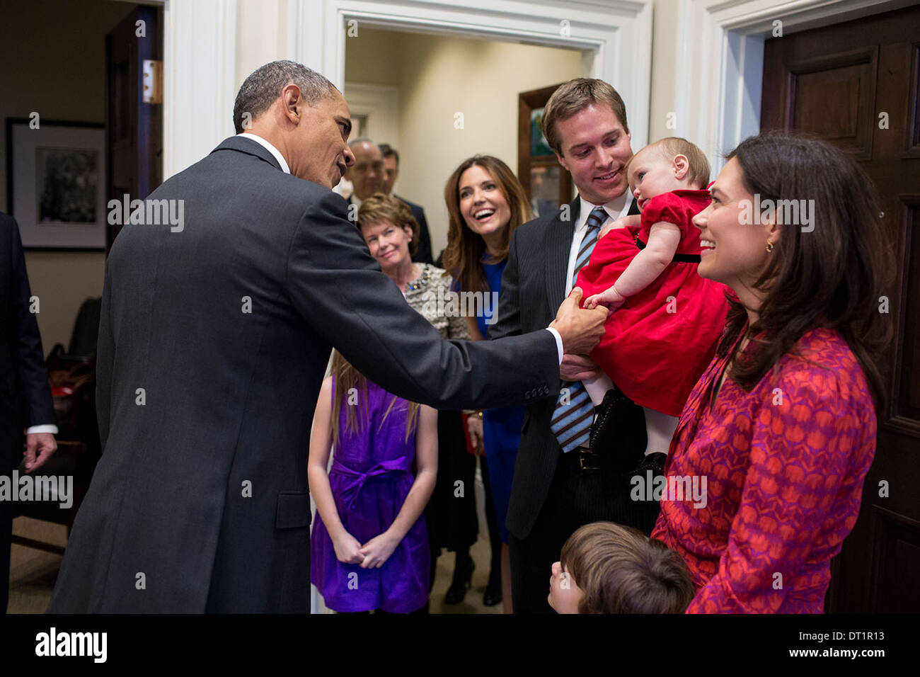 US President Barack Obama greets the daughter of a departing staff ...