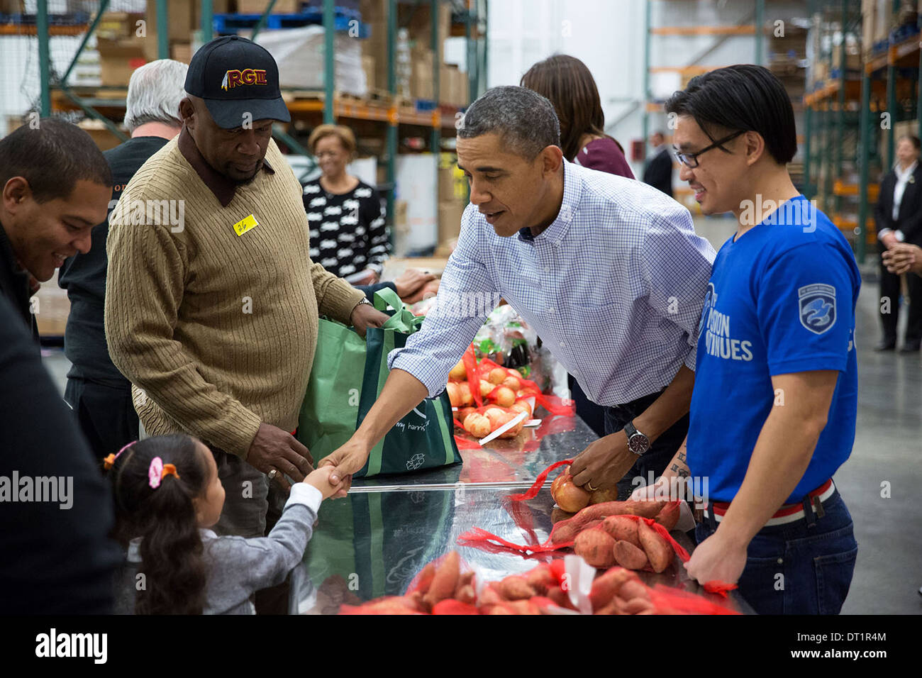 US President Barack Obama shakes hands with a young girl while he ...