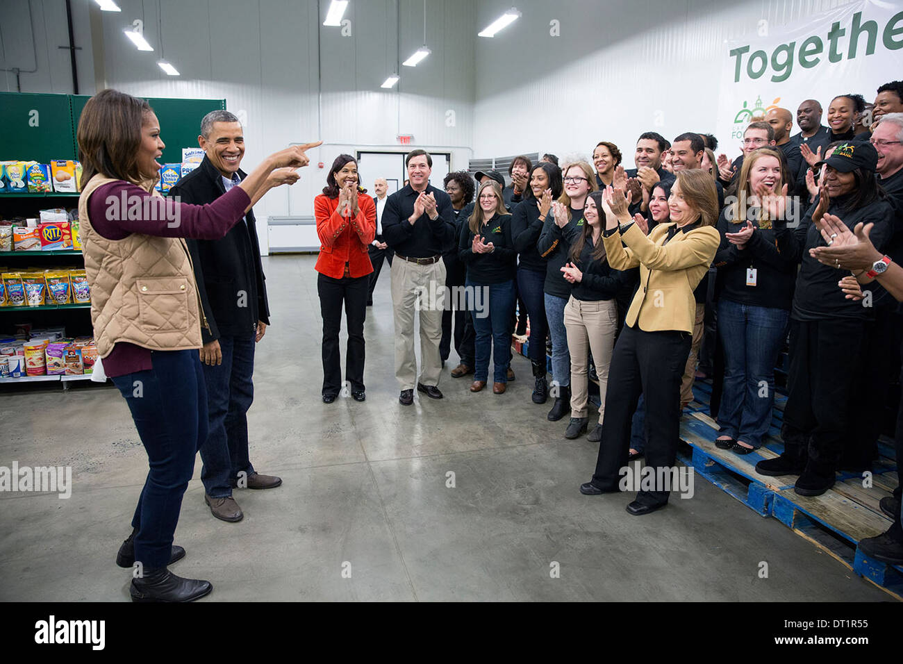 US President Barack Obama and First Lady Michelle Obama greet staff and ...