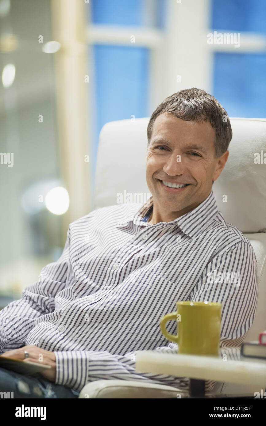 Woman relaxing at home with coffee Stock Photo - Alamy