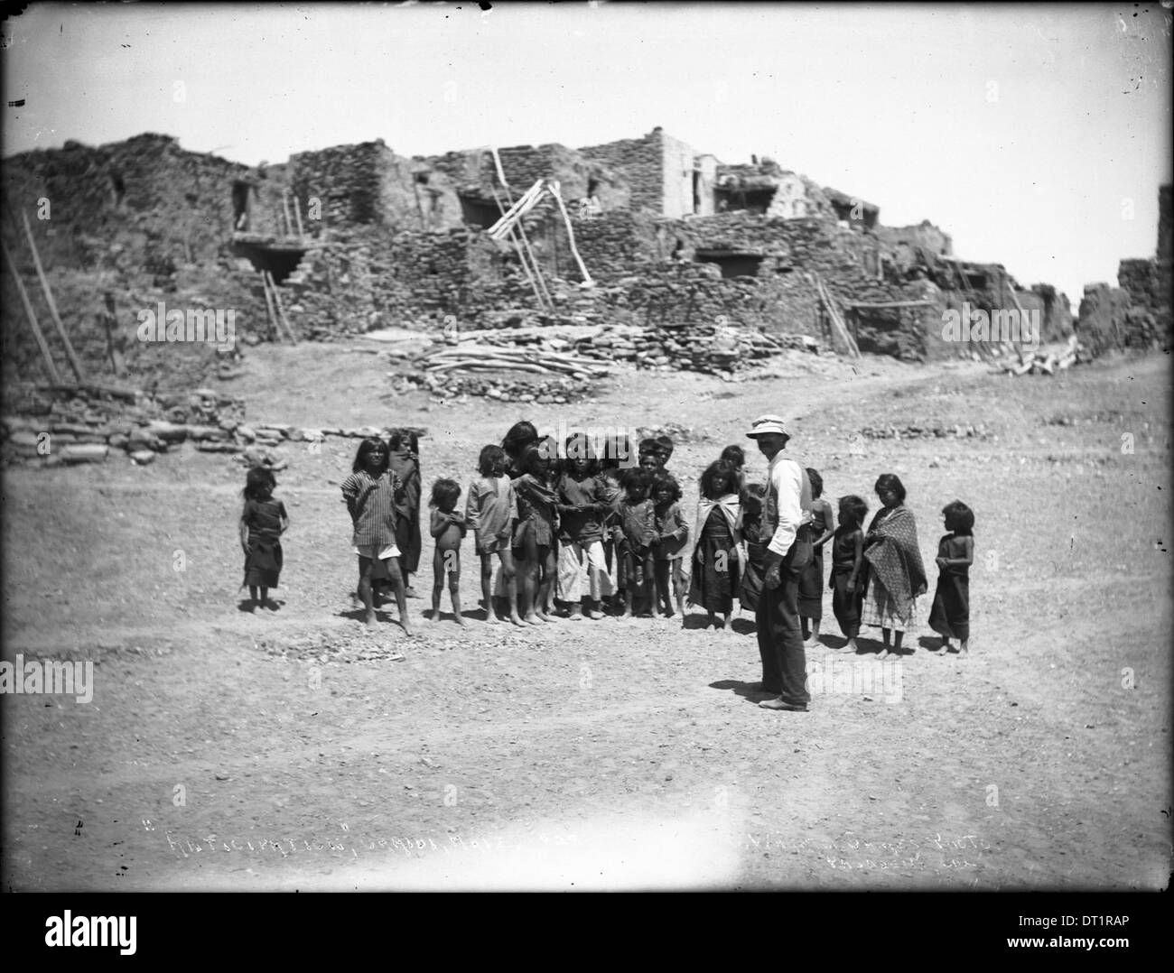 A group of twenty-two Hopi children lined up, waiting for candy, in ...