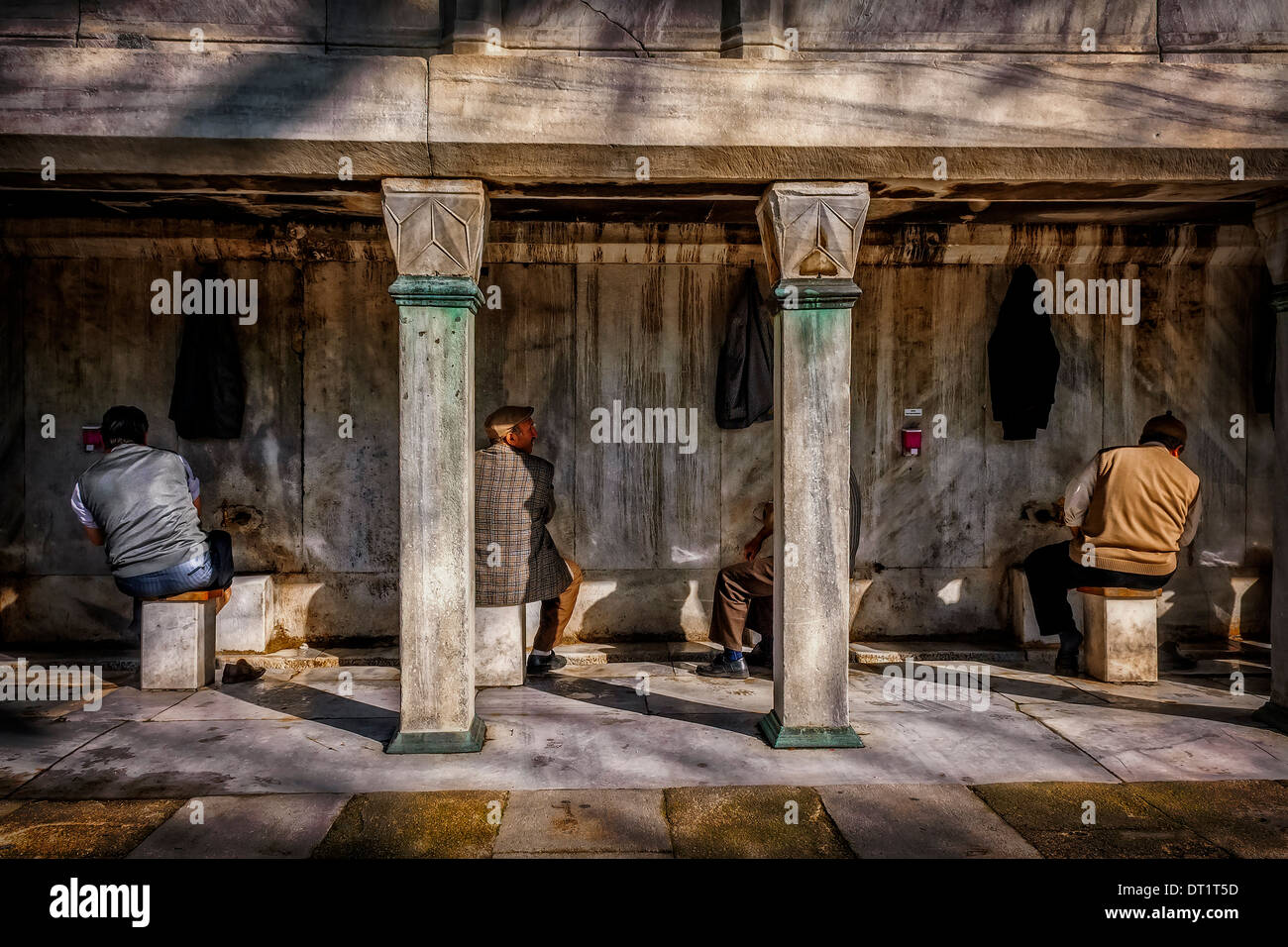 Muslim men are performing a ritual purification before they pray in the ...