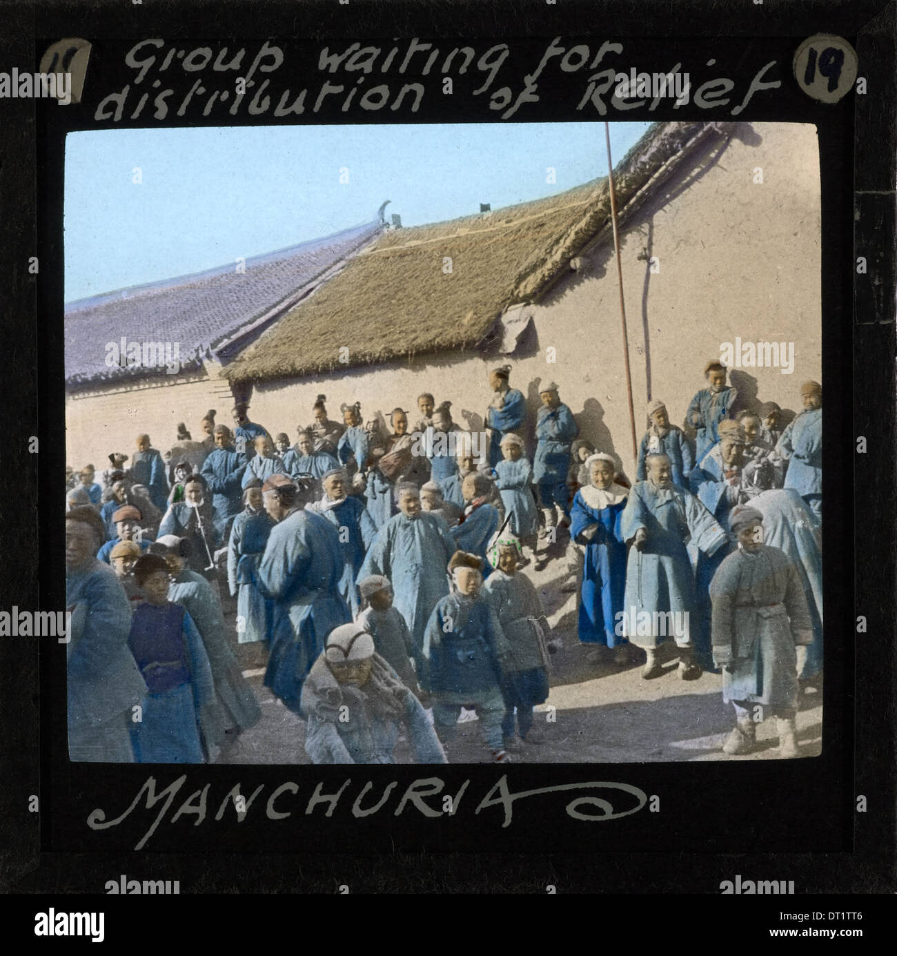 A photograph showing a group of people waiting for relief distribution ...