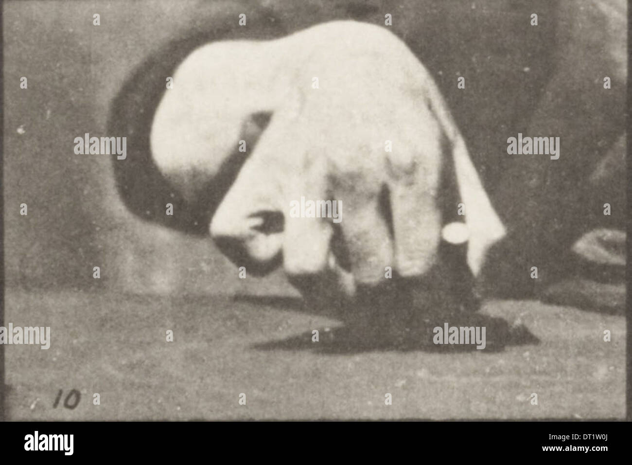 A photograph of a hand drawing a circle, focusing on the act of drawing ...