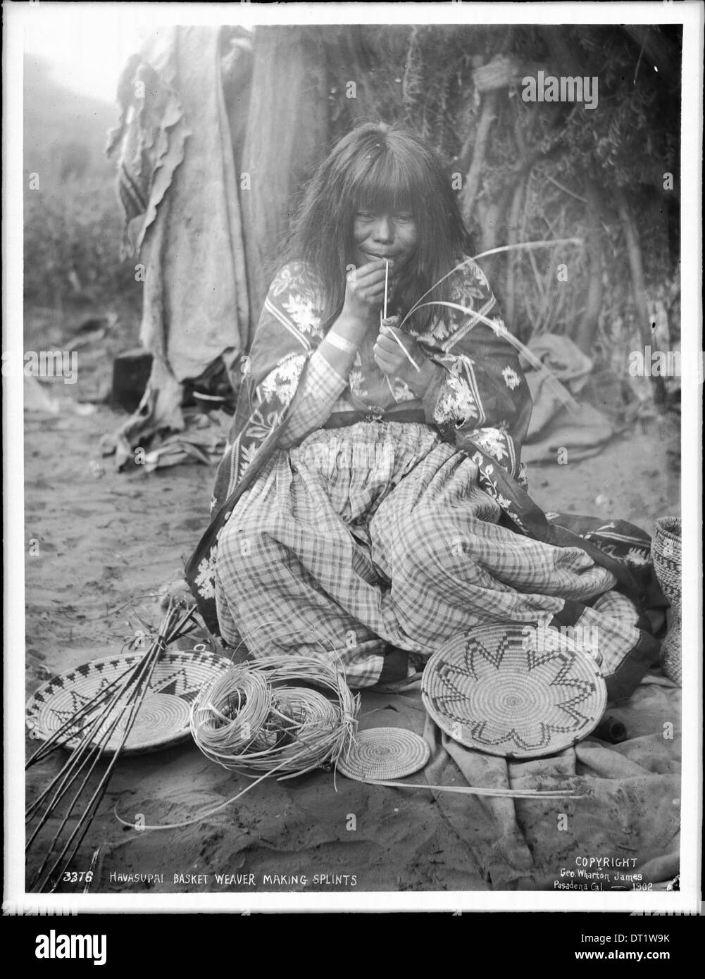 A photograph of a Havasupai Indian woman weaving basket splints, taken ...