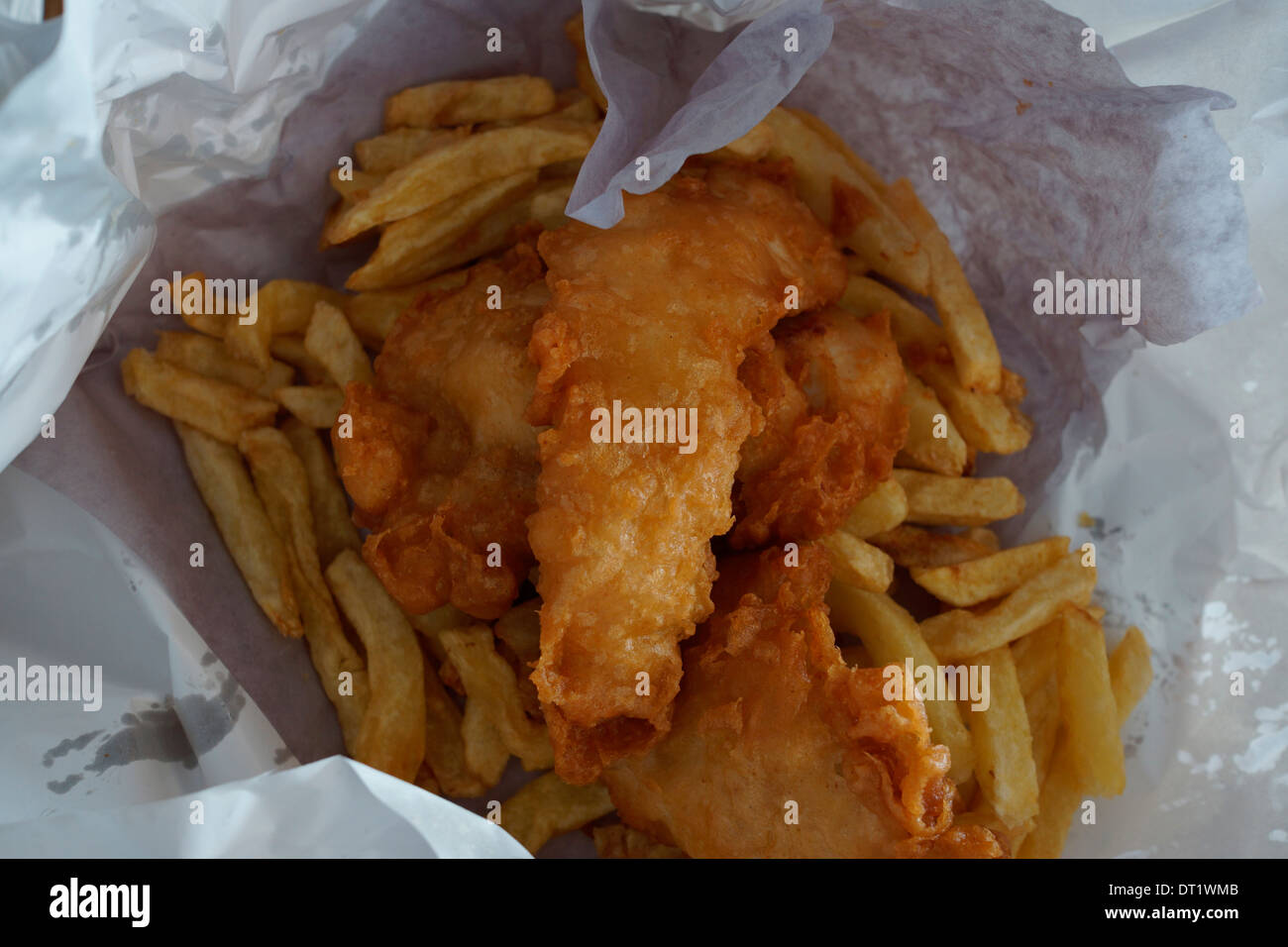 Fried fish and chips in paper wrapping Stock Photo - Alamy
