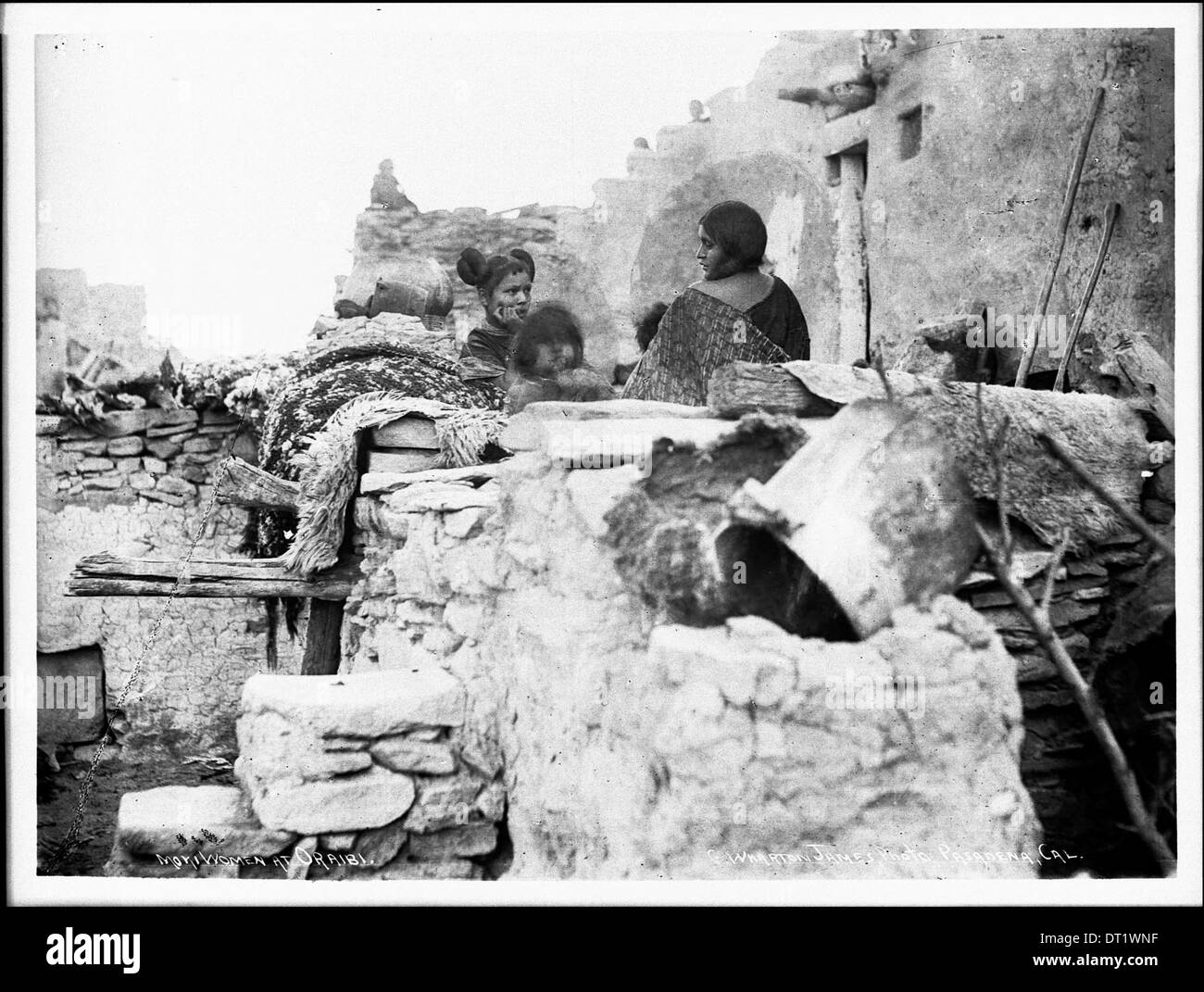 A photograph of a Hopi ('Moki') Indian family standing in front of ...