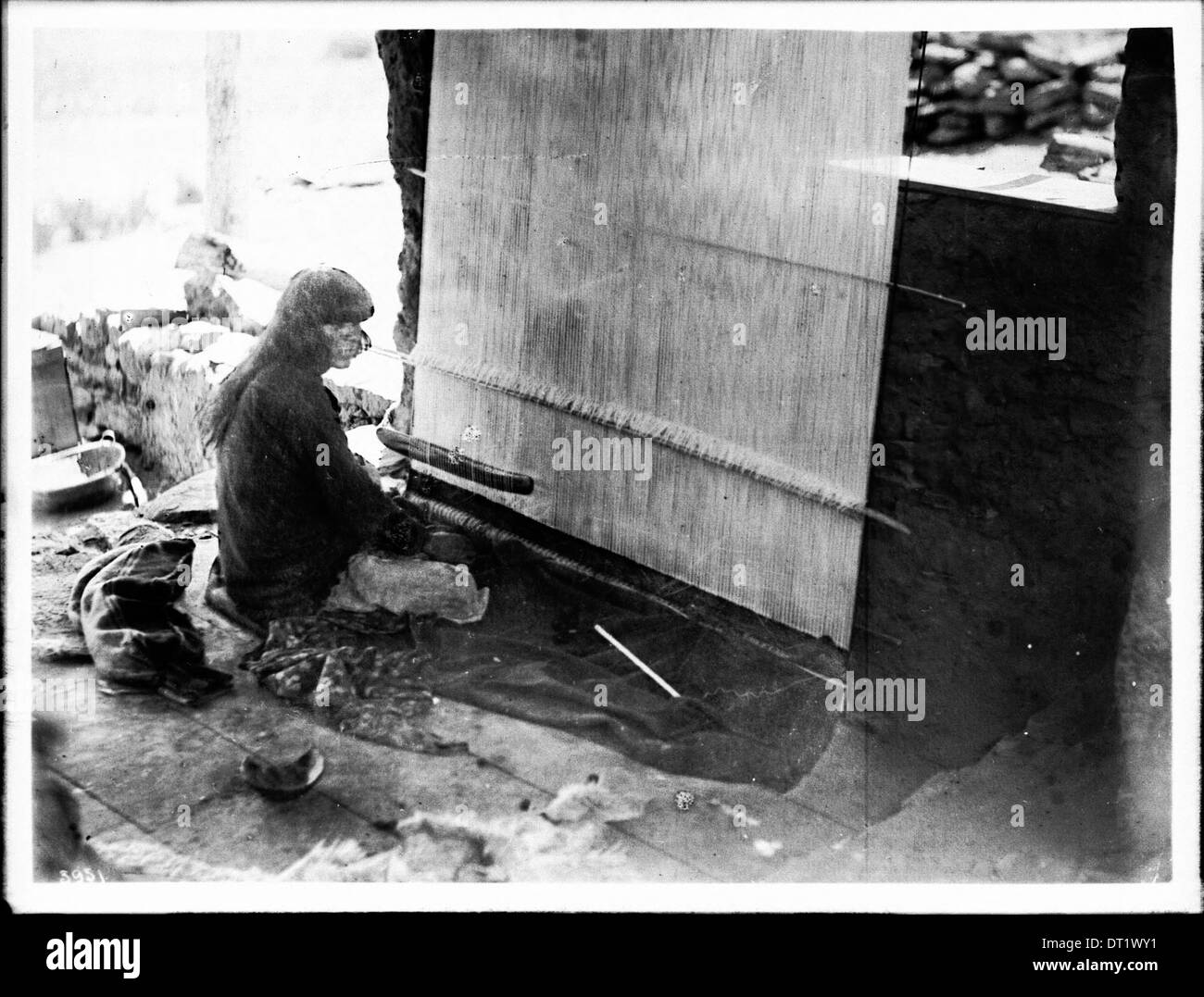 A photograph of a Hopi Indian man weaving a traditional blanket, taken ...