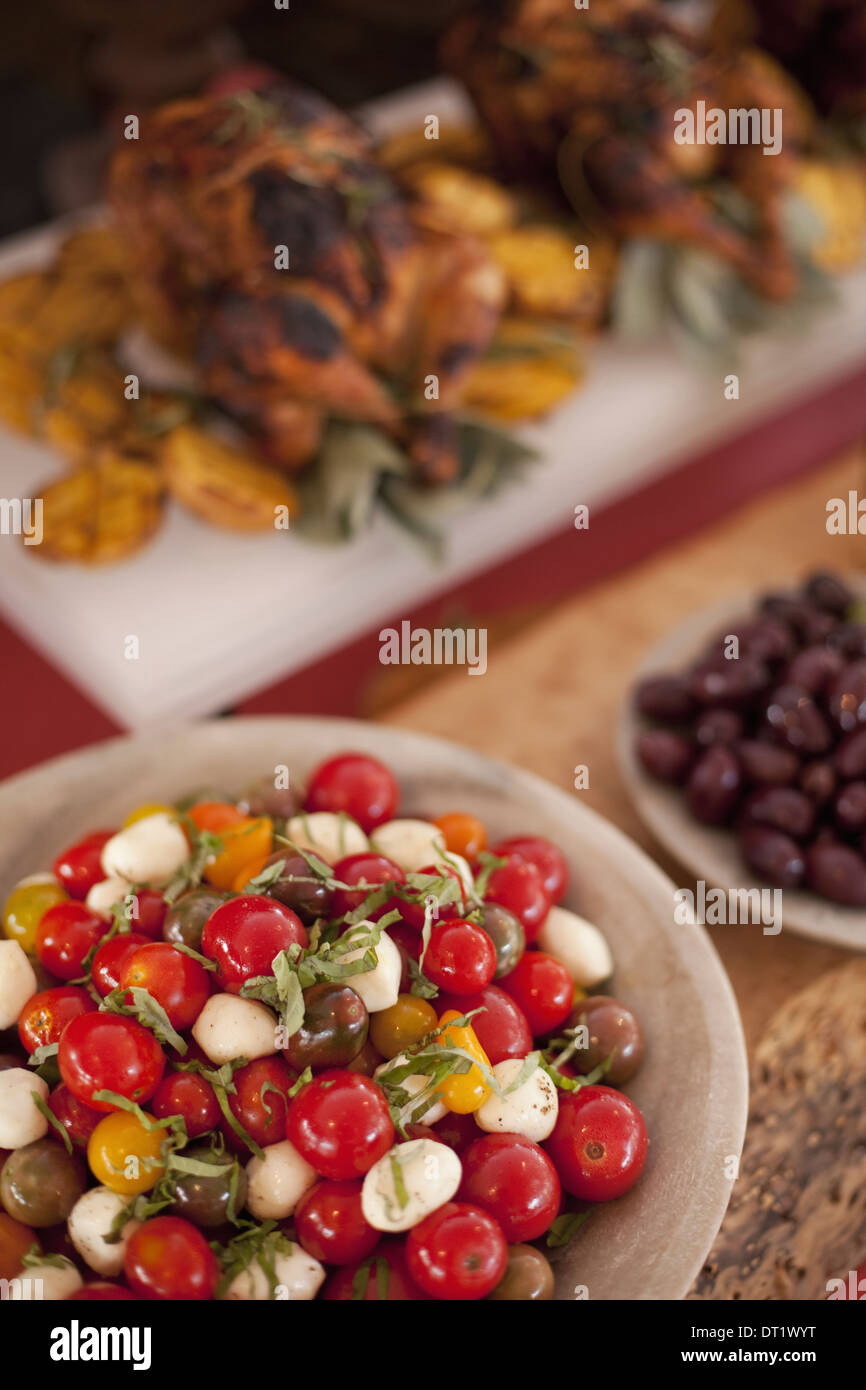 A buffet table laid out for a party Organic food Salads and a chicken ...