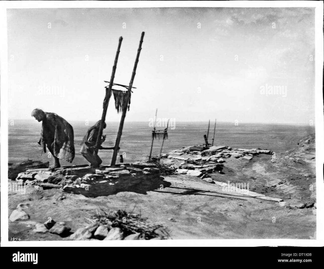 A photograph of Hopi Indian priests emerging from their Kivas prior to ...