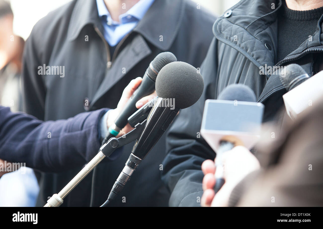 A journalist is making a interview with a microphone Stock Photo - Alamy