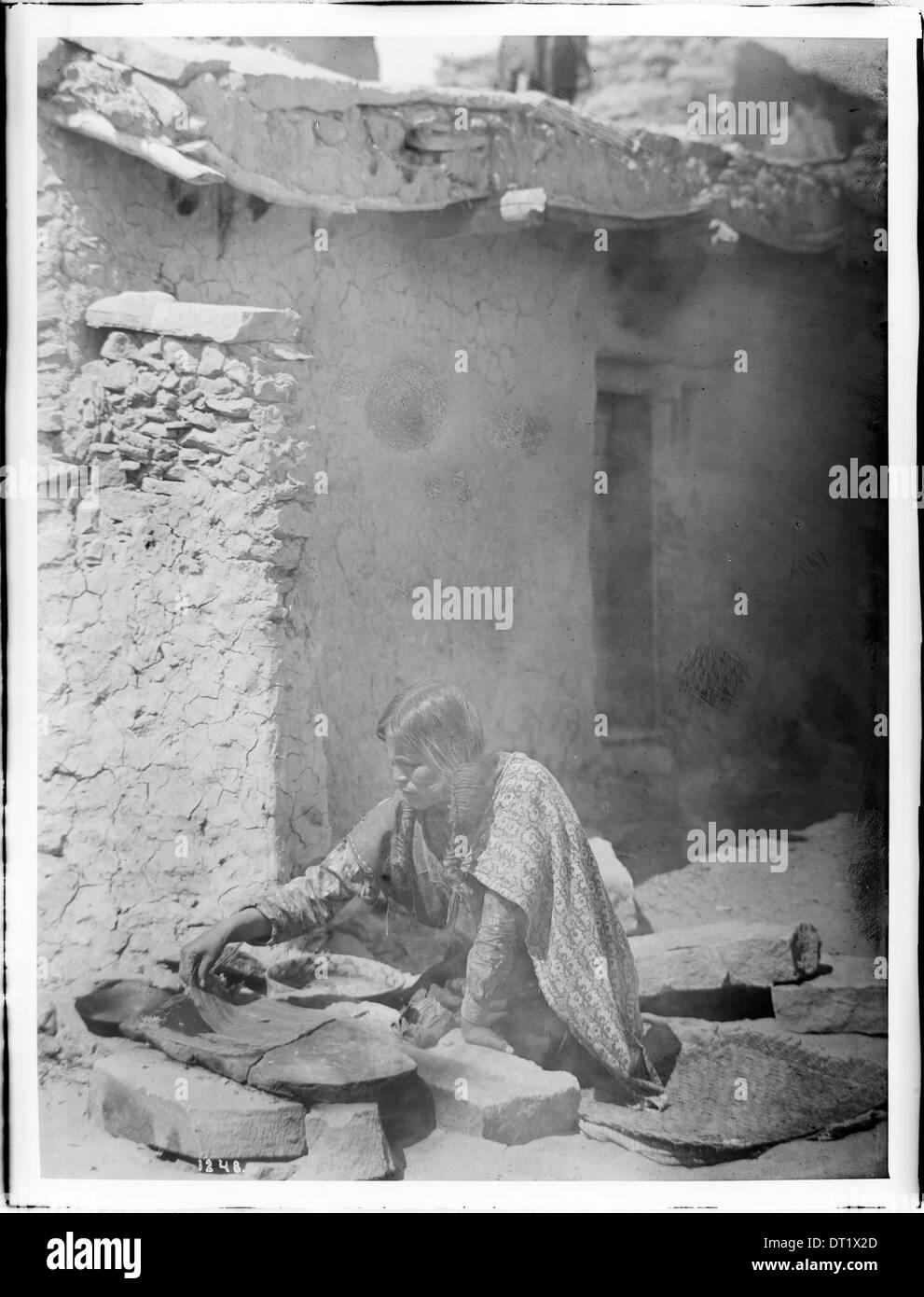 A Hopi Indian woman making piki, a traditional bread, in the village of ...
