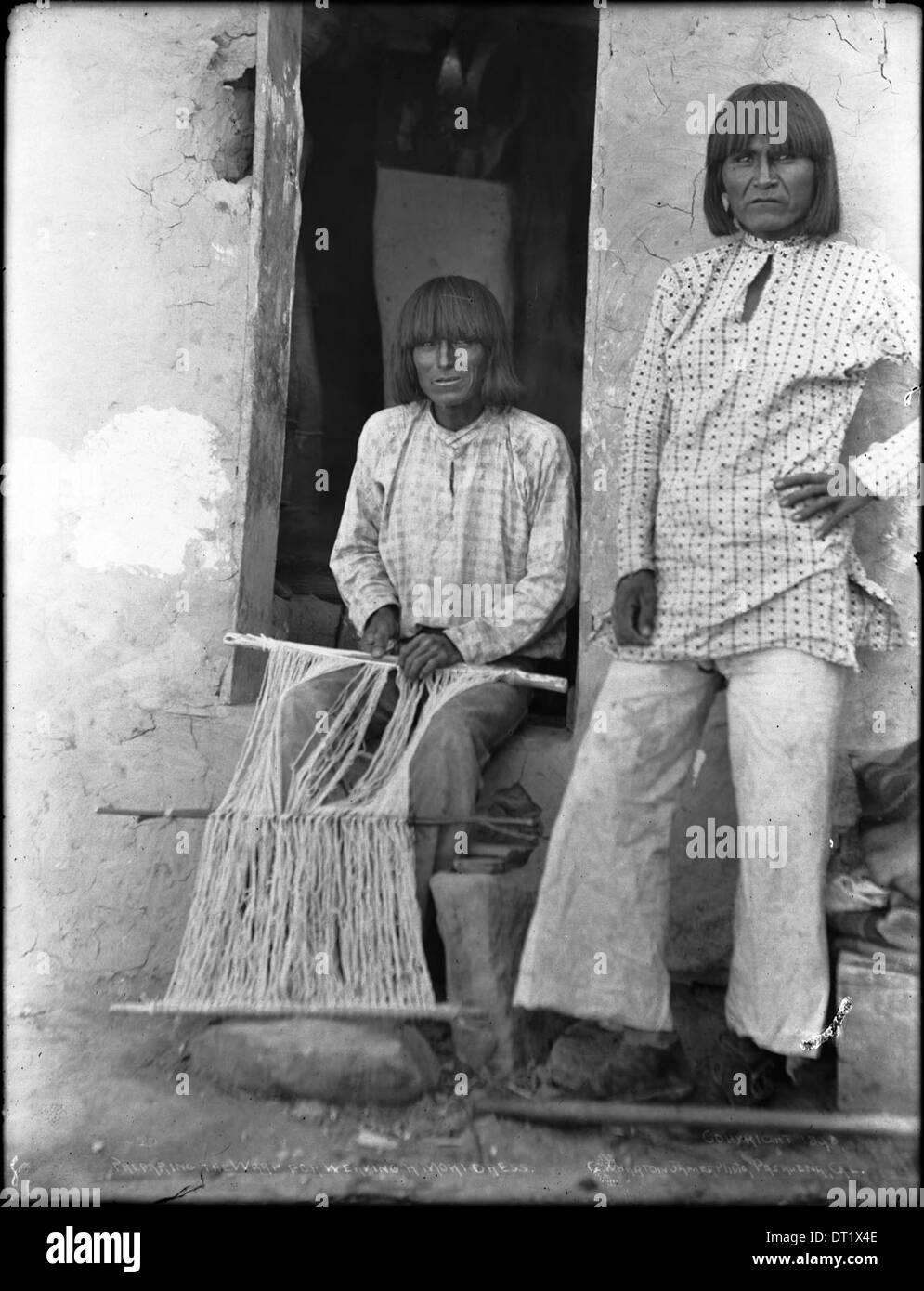 A photograph of Hopi men preparing a warp for weaving a traditional ...