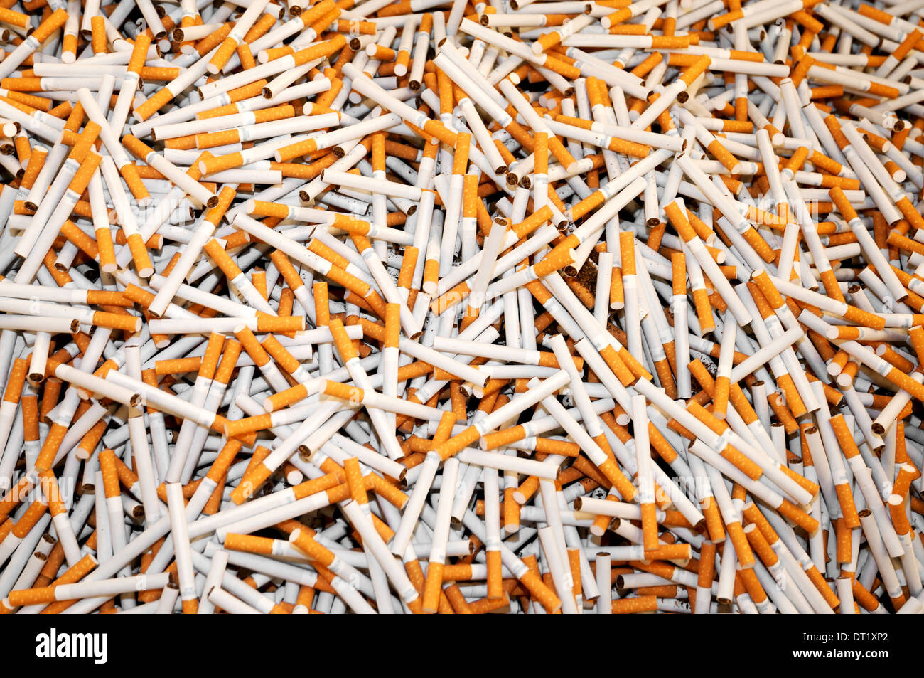 A huge pile of smoking cigarettes scattered in disarray Stock Photo - Alamy