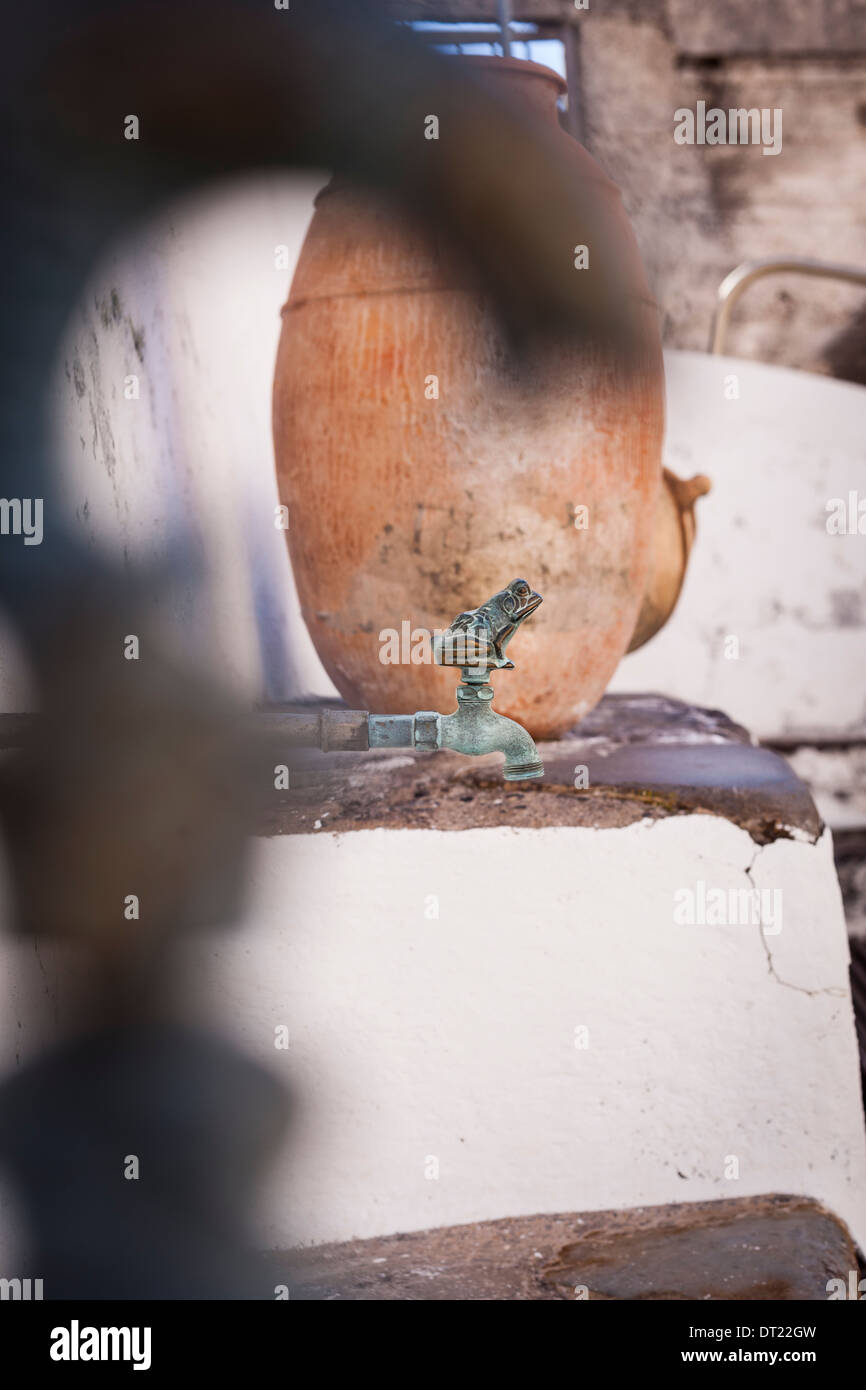 Brass frog tap and pottery urn at the old communal water supply in ...