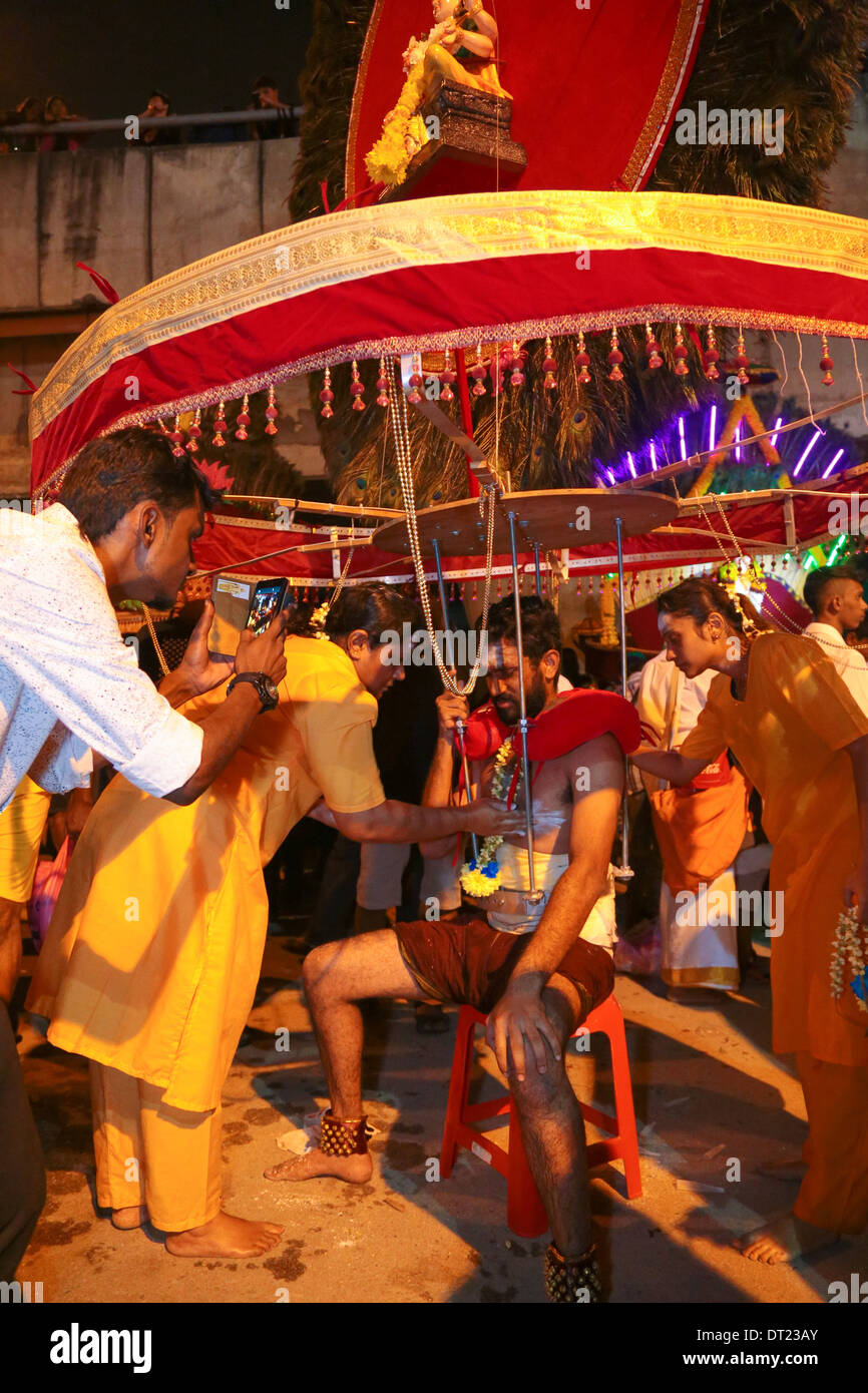 Blessing of Thaipusam kavadi bearer by family members at Batu Cave ...