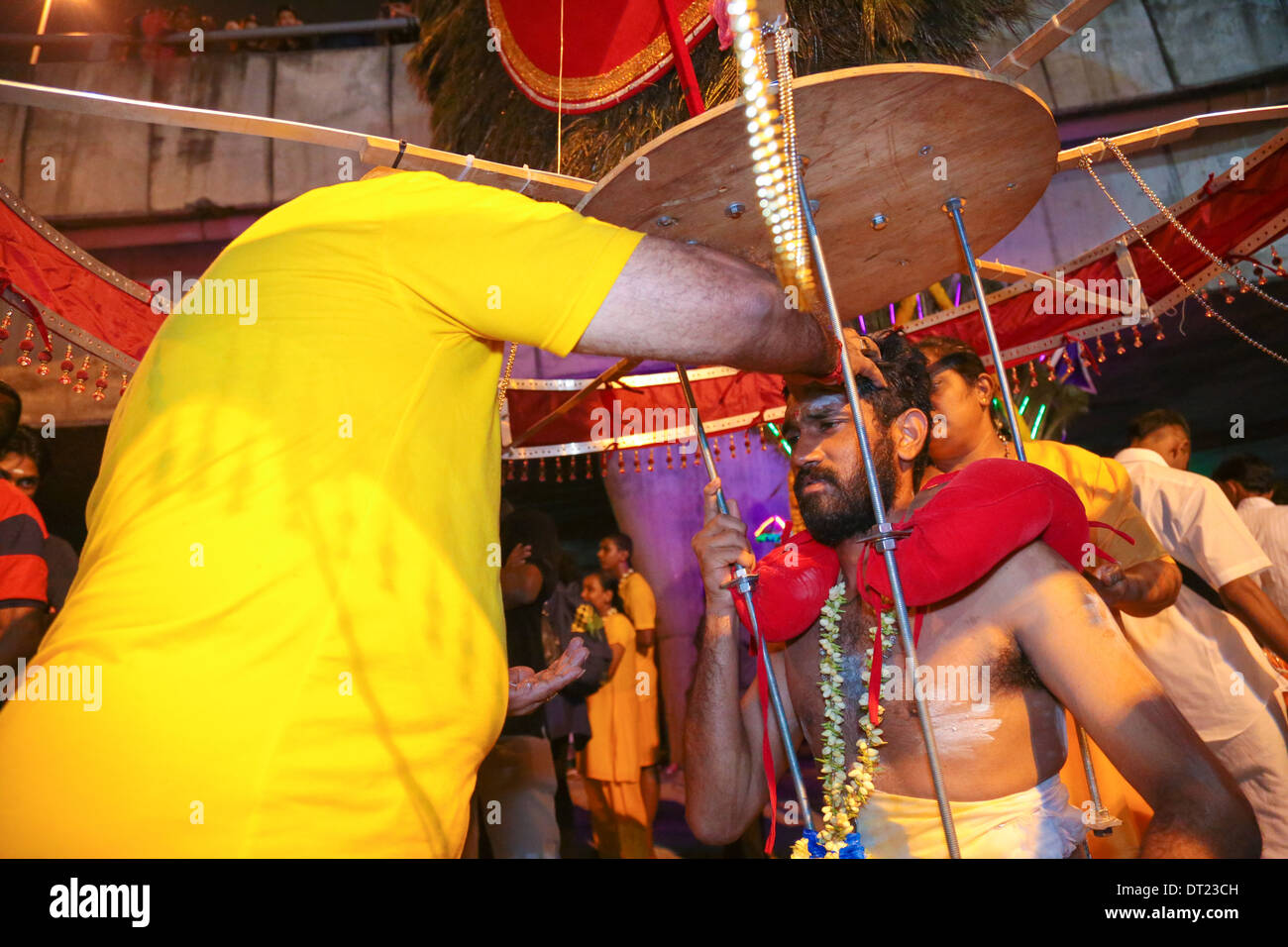 Blessing of Thaipusam kavadi bearer by a hindu priest at Batu Cave ...