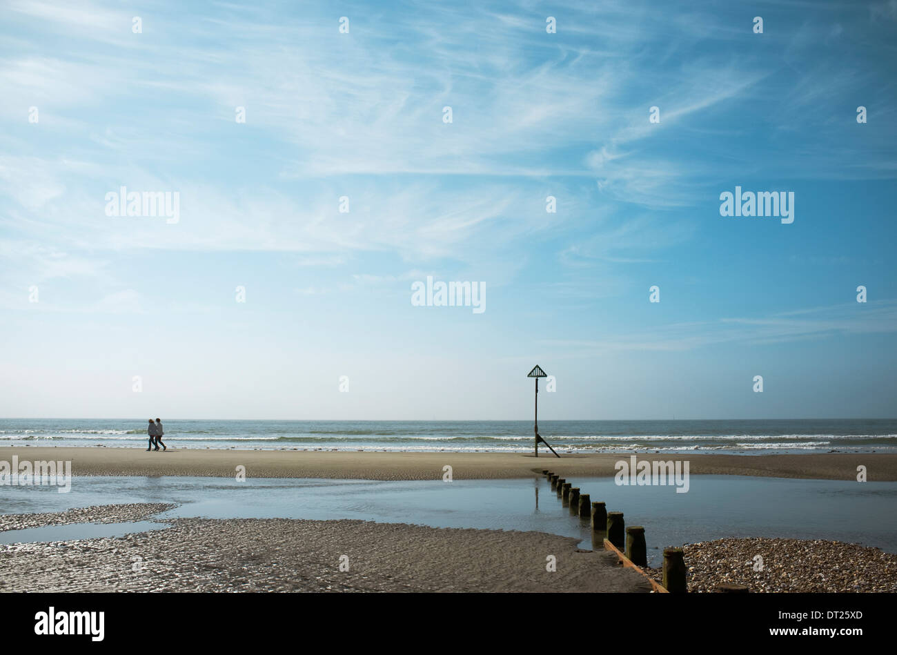 Wooden groynes down the sandy beach at West Wittering near the mouth of ...