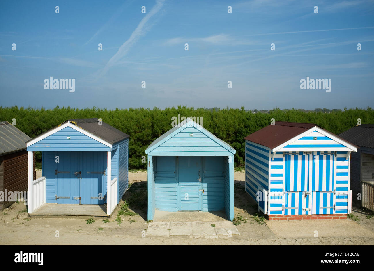 Colourful wooden beach huts along the sandy beach at West Wittering ...