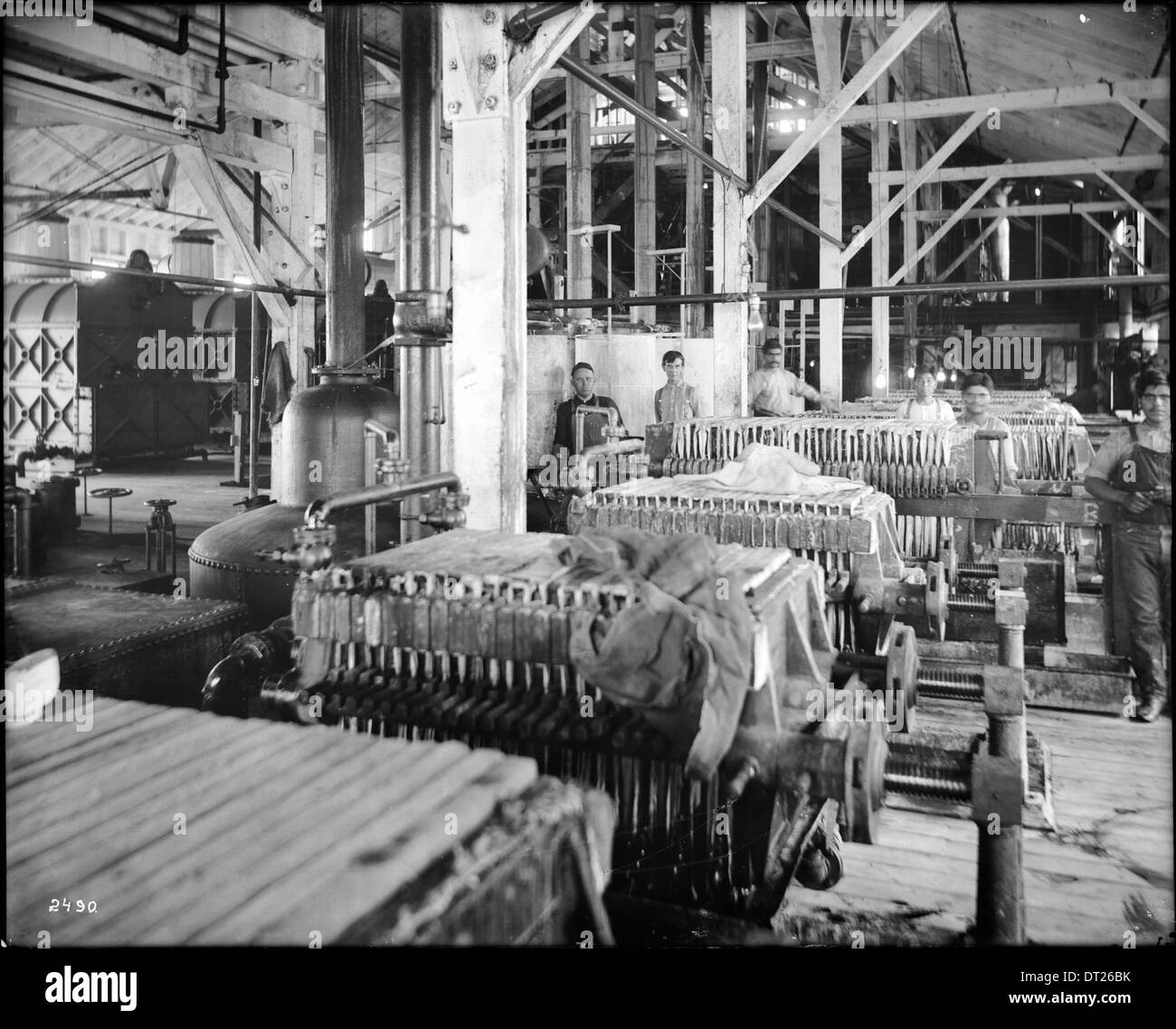 A photograph of the interior of a beet sugar factory, featuring filter ...