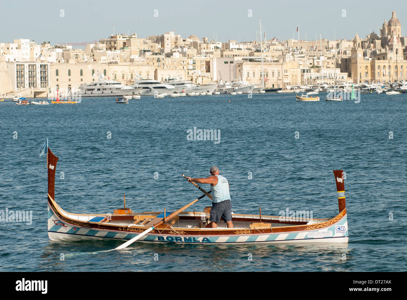 Maltese man rowing a traditional craft at a regatta on Grand Harbour ...