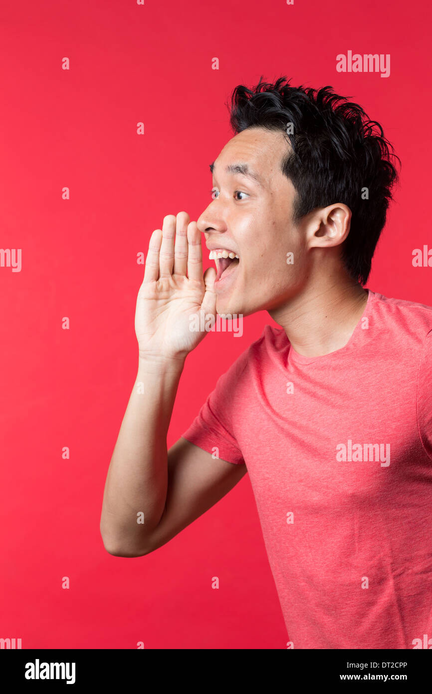 Side view Portrait of a happy Chinese/Asian man shouting. Red ...
