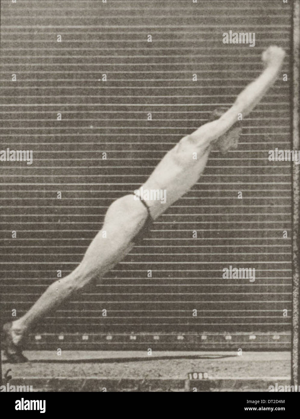 A man in a pelvis cloth is shown performing a standing broad jump ...