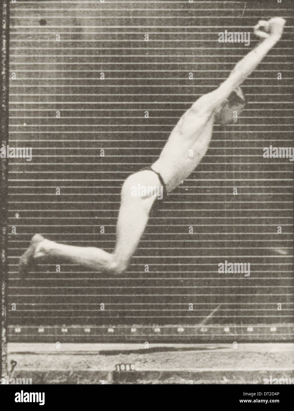 A man wearing a pelvis cloth performs a standing broad jump, captured ...