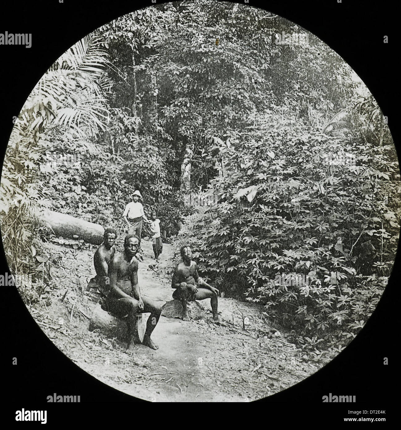 A photograph showing a missionary with a group of men in the Congo ...