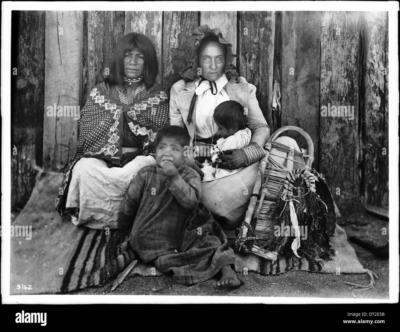 A photograph of a missionary woman visiting a Walapai Indian family in ...