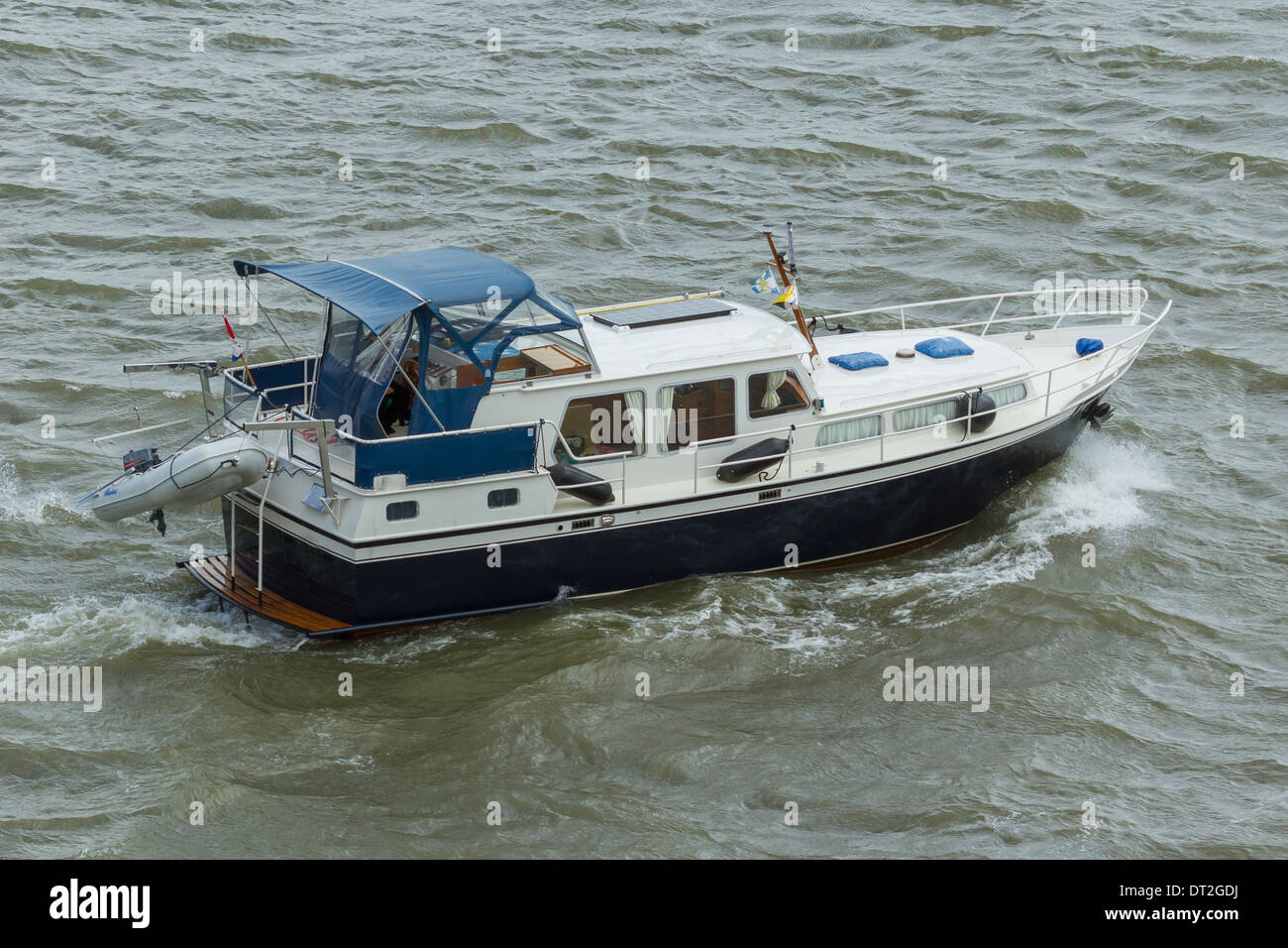 Small yacht sailing through the harbor of Rotterdam (Holland Stock ...