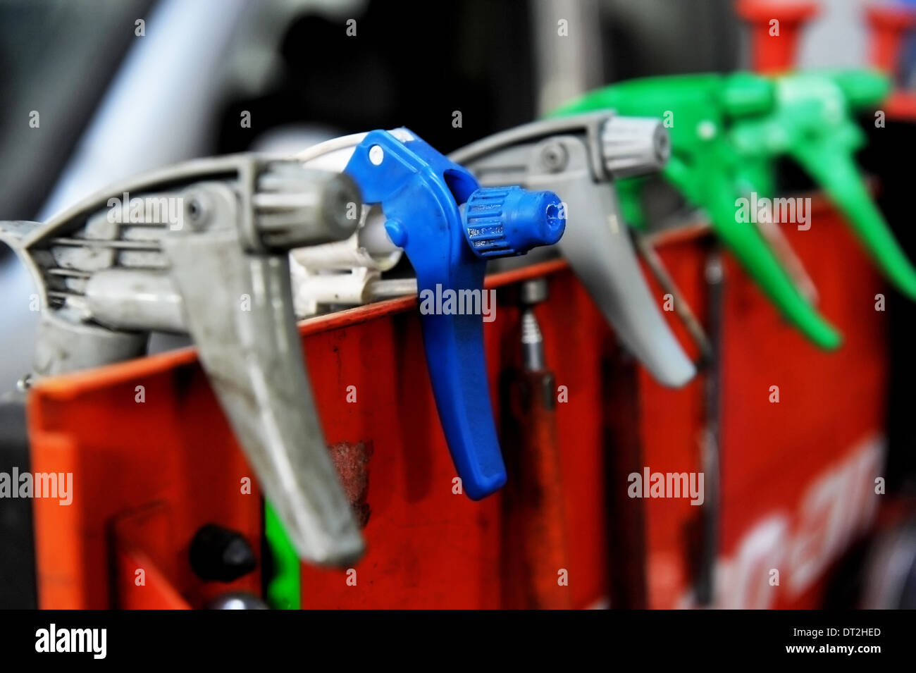 Different color spray bottles in a car service Stock Photo - Alamy