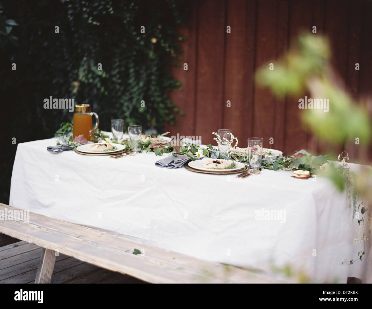 A table laid for a special meal Place settings with plates and cutlery ...