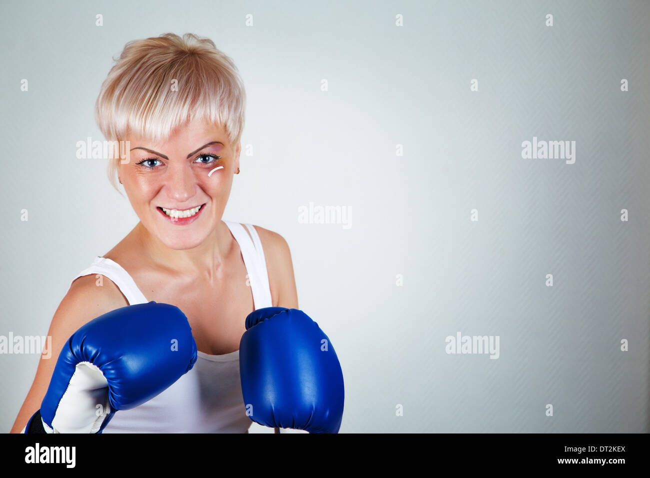 angry woman with bruise boxing at gray background Stock Photo - Alamy