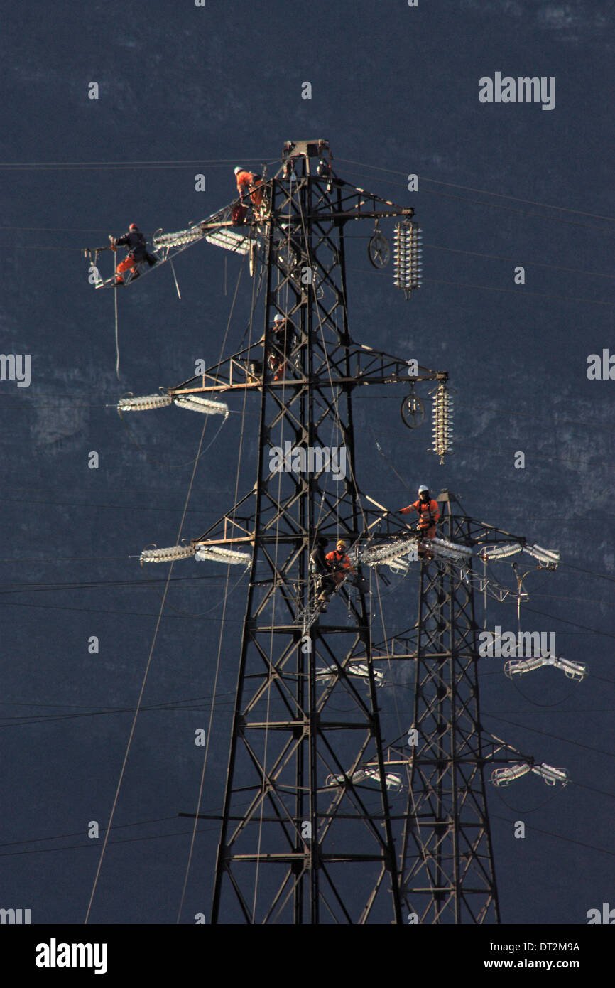 Workers at electricity pylons in Italy. Maintenance work of a high ...
