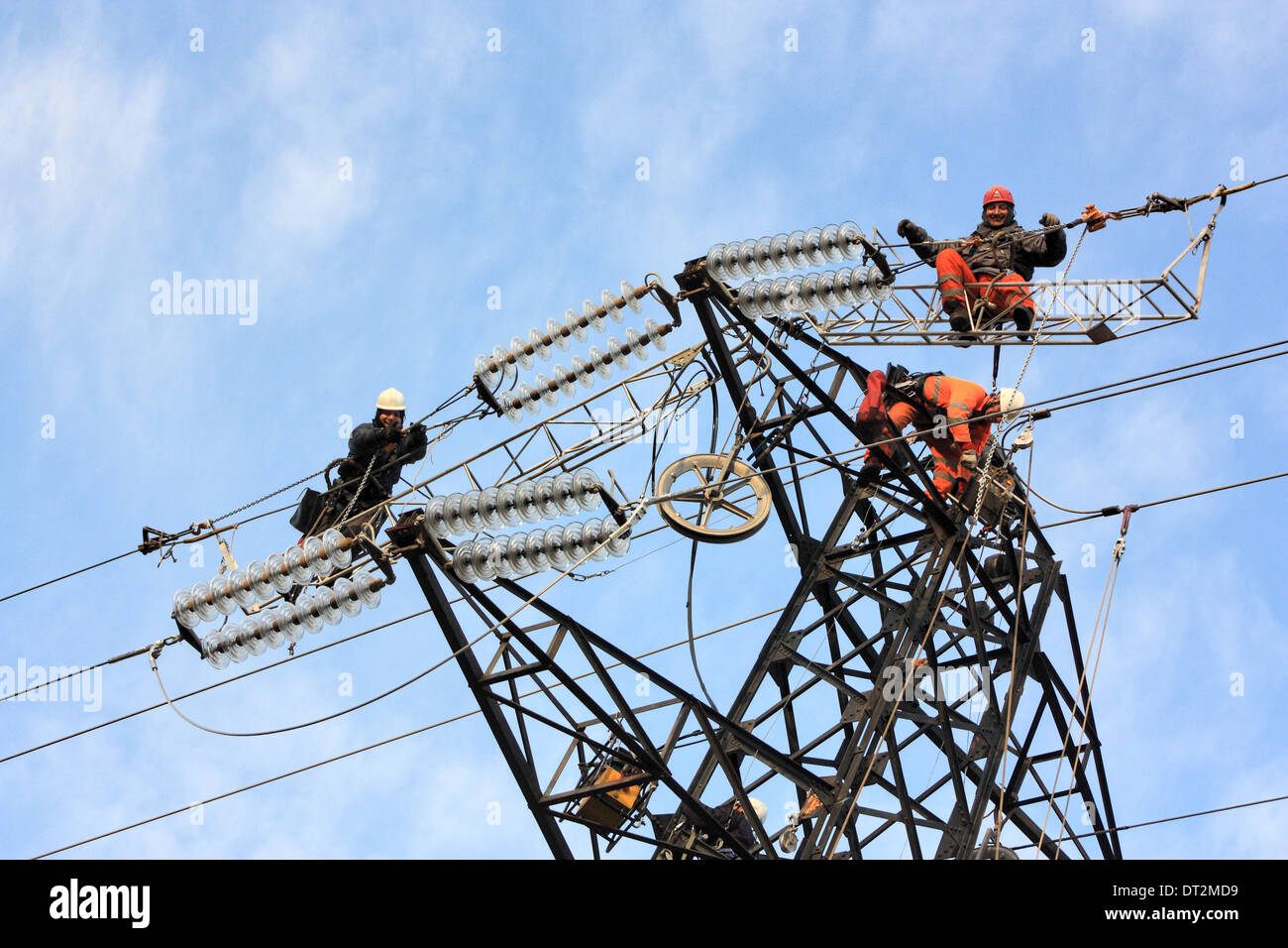 Workers at electricity pylons in Italy. Maintenance work of a high ...