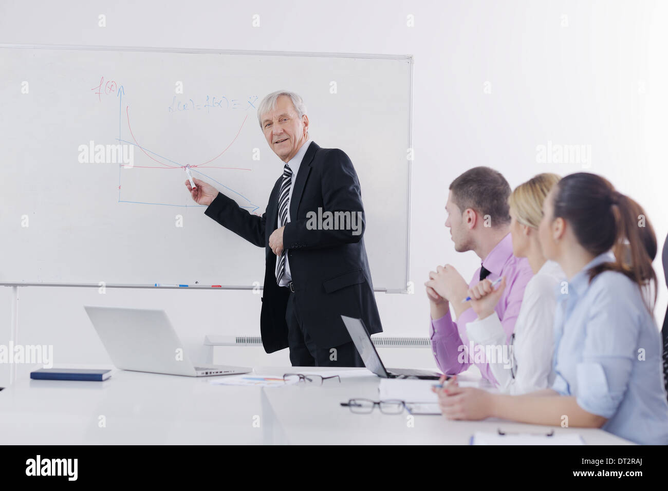 Senior business man giving a presentation Stock Photo - Alamy