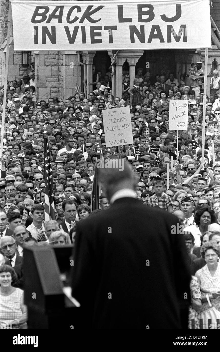 US President Lyndon B. Johnson addressing a crowd displaying a banner ...