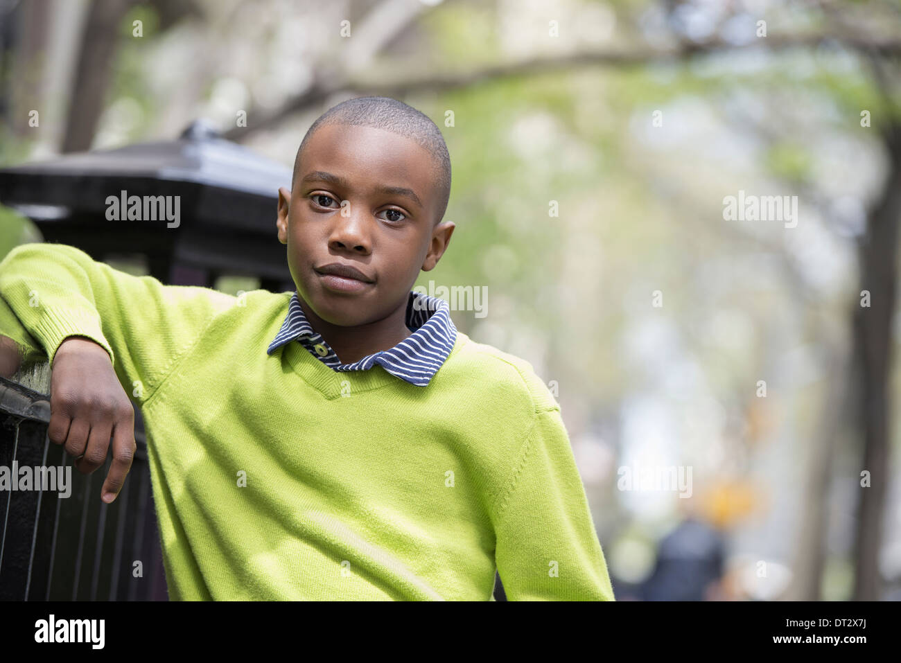 Boy leaning railing outdoors hi-res stock photography and images - Alamy