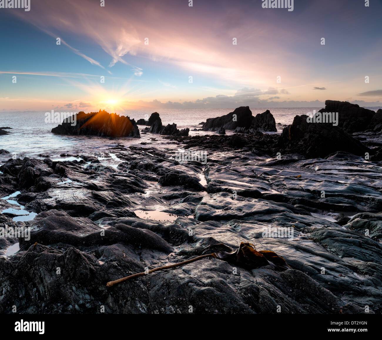 Ocean sunrise on a rocky beach at Looe in south Cornwall Stock Photo ...