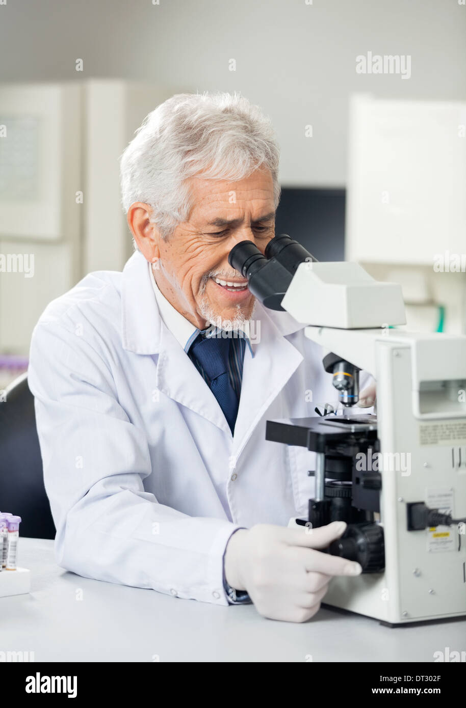 Smiling Scientist Using Microscope In Laboratory Stock Photo - Alamy