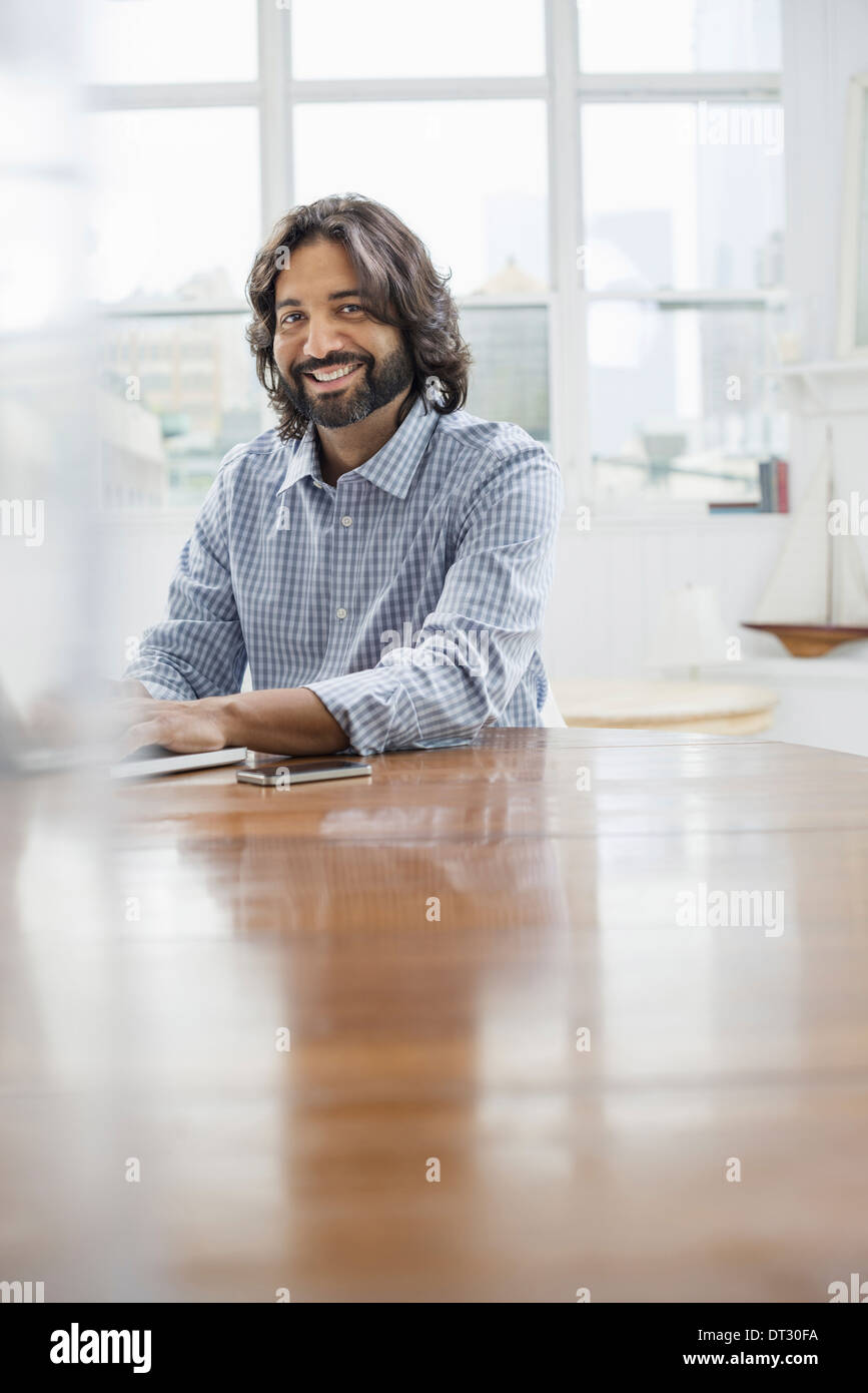 Young man seated table hi-res stock photography and images - Alamy